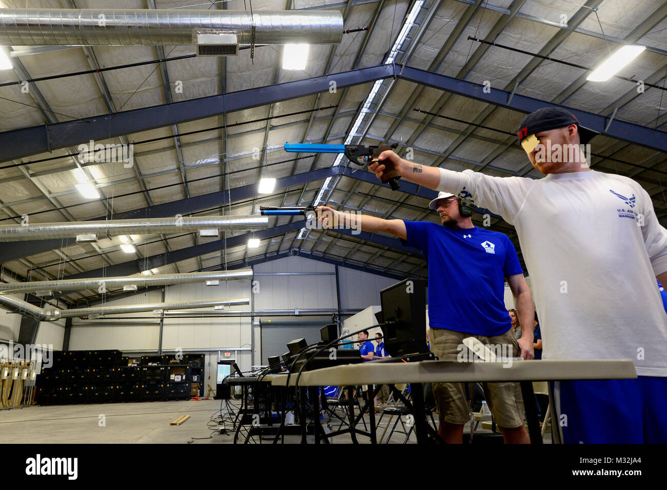 Air Force Trials pistol shooting competitors prepare to fire during the ...