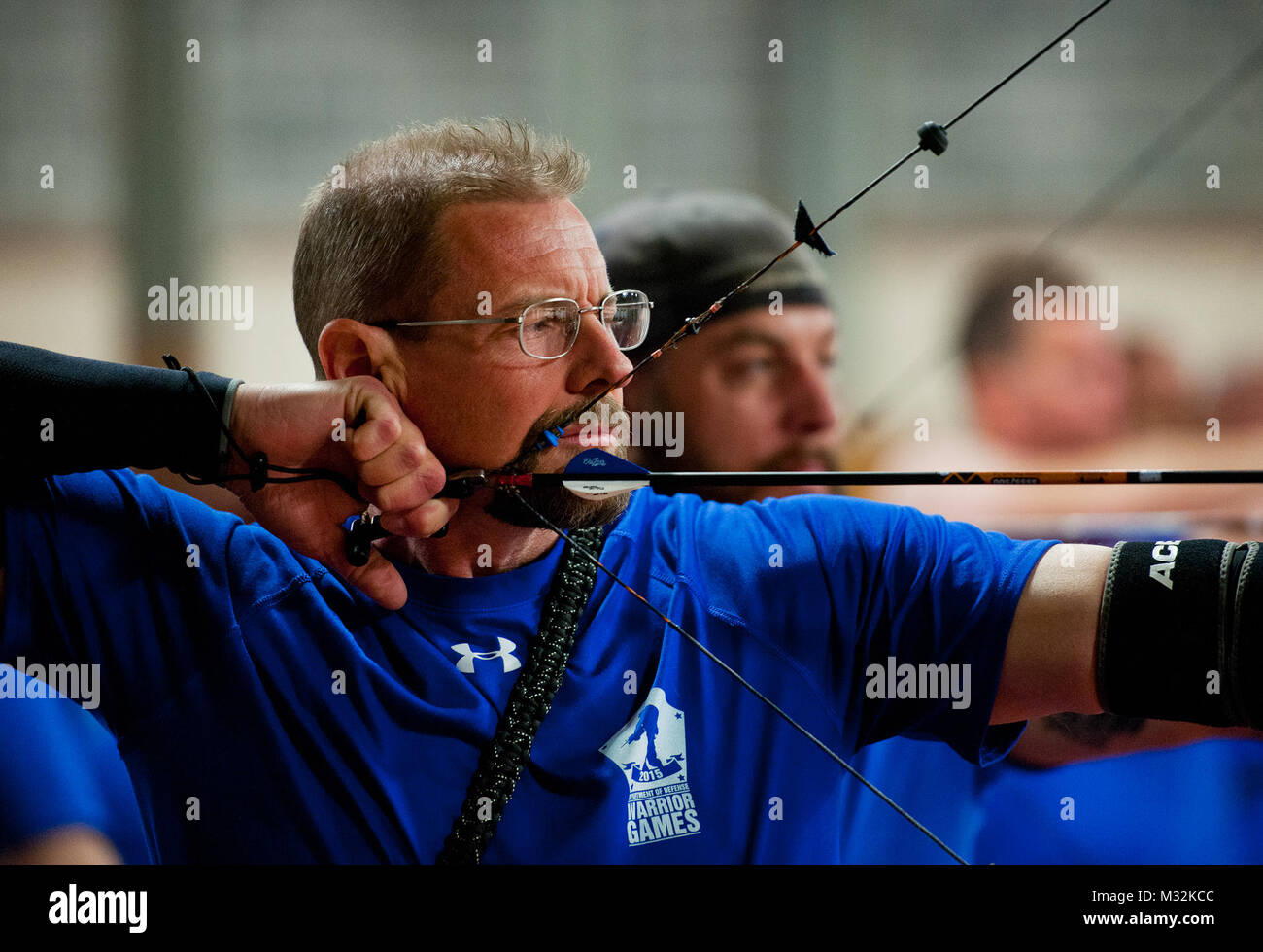 Scott Addington, a Warrior Games athlete, pulls back his bow string ...