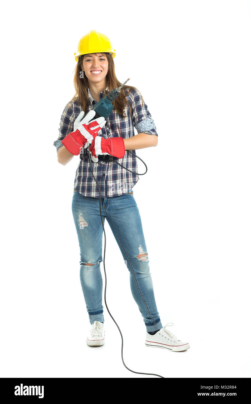 Attractive young woman builder with drill tool happy for good work ...
