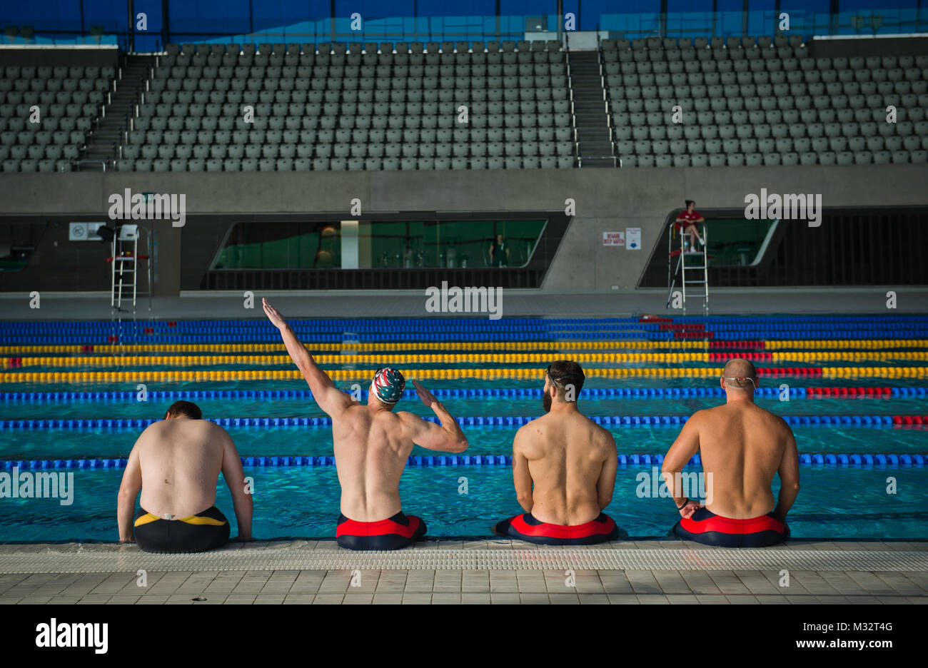 John Edmonston, a retired Navy Lt., flexes as he jokes with a few of ...