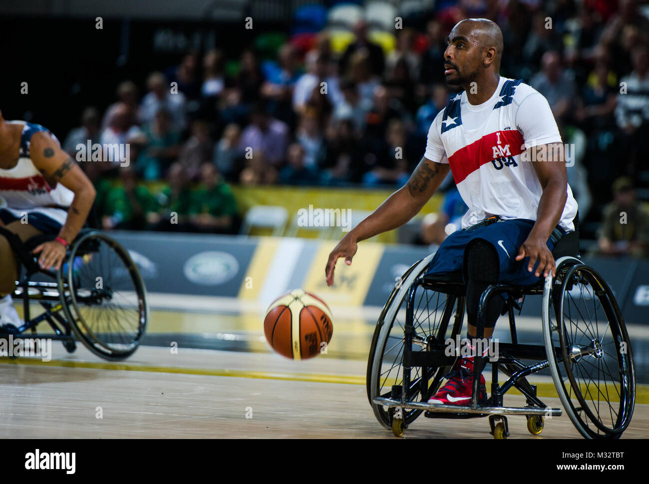 Delvin Maston dribbles down court during a wheelchair basketball match ...