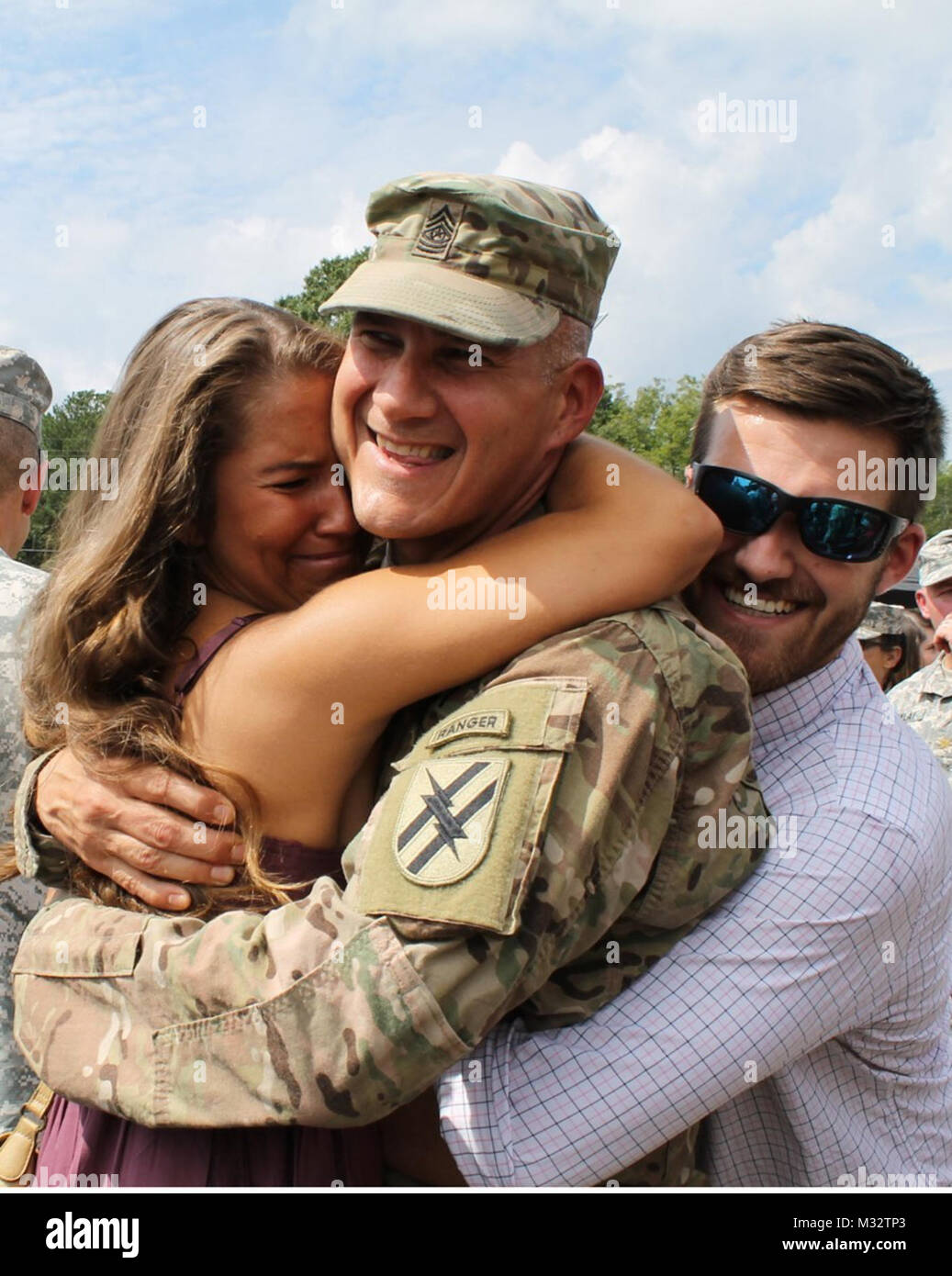 Command Sgt. Maj. Shawn Lewis is immediately hugged by family after the ...