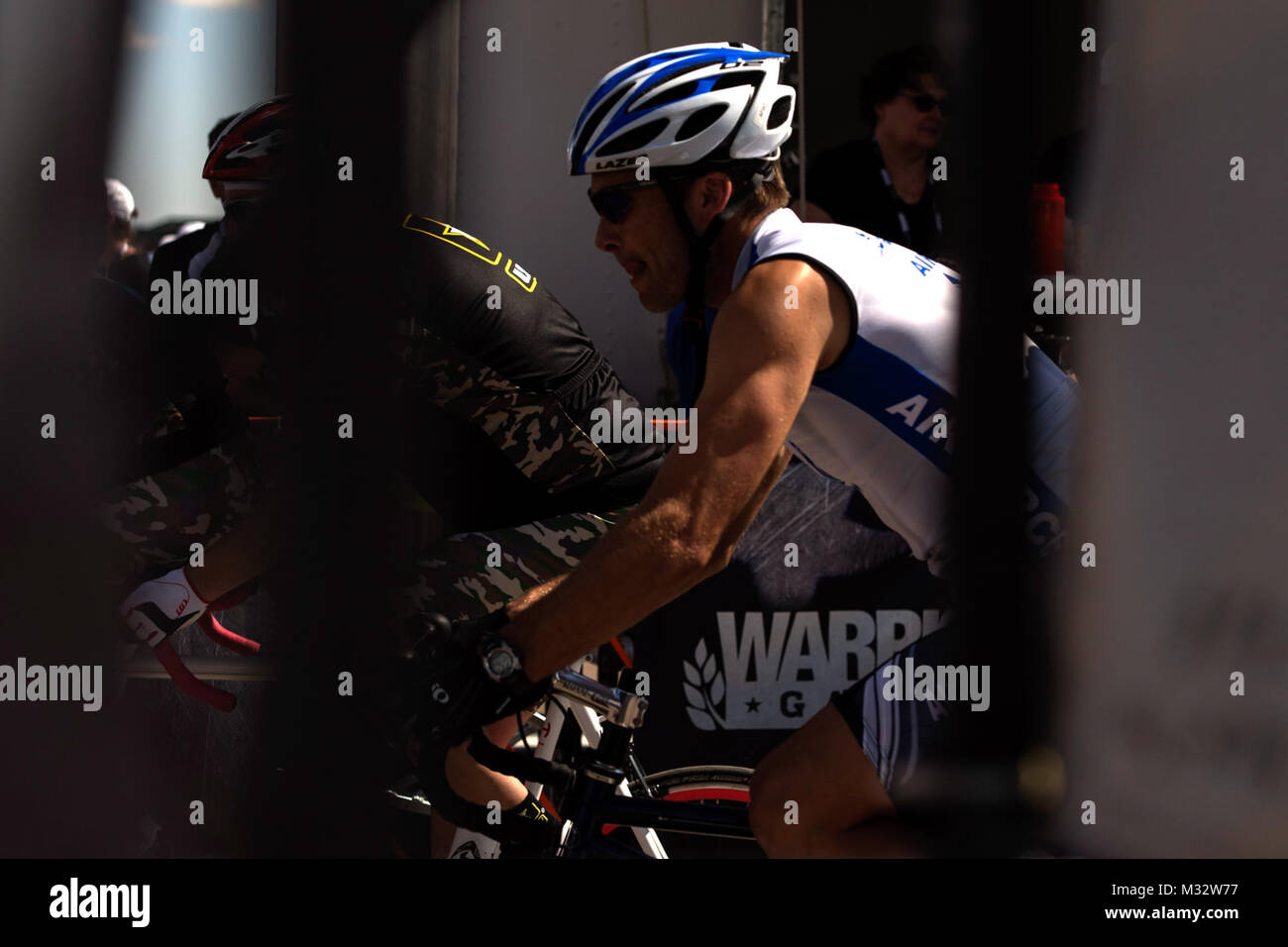 Air Force Warrior team coach James Bales leads cyclist Wesley Glisson ...