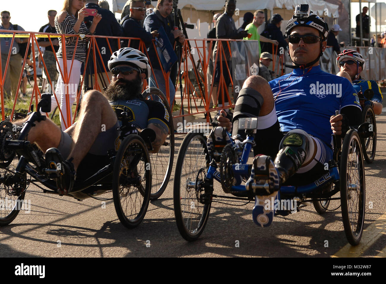 Air Force athlete Chris Aguillera(right) participates in a cycling race ...