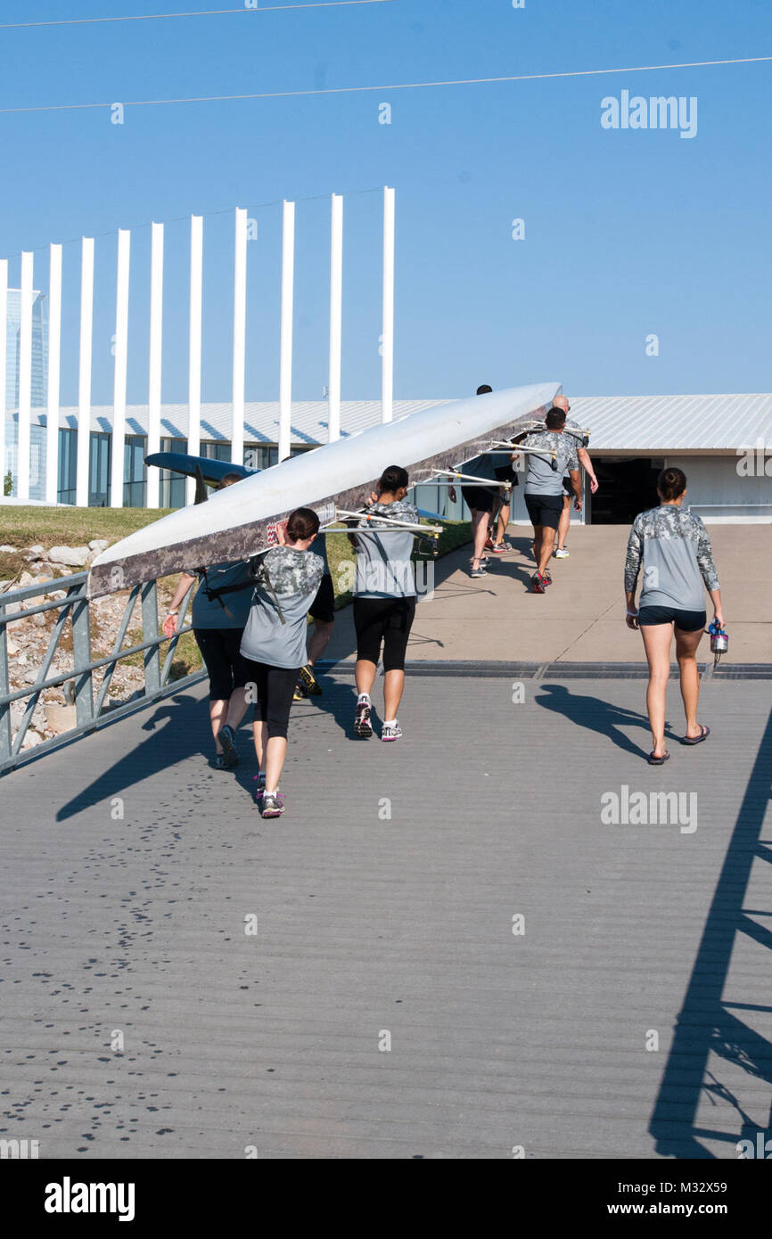 Eight members of the Oklahoma Army National Guard Rowing Team carry ...