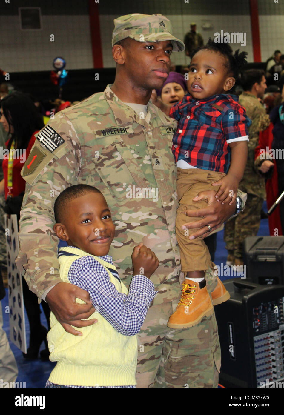 Sgt. Jerry Wheeler embraces his children, Zion and Zamari, during a ...