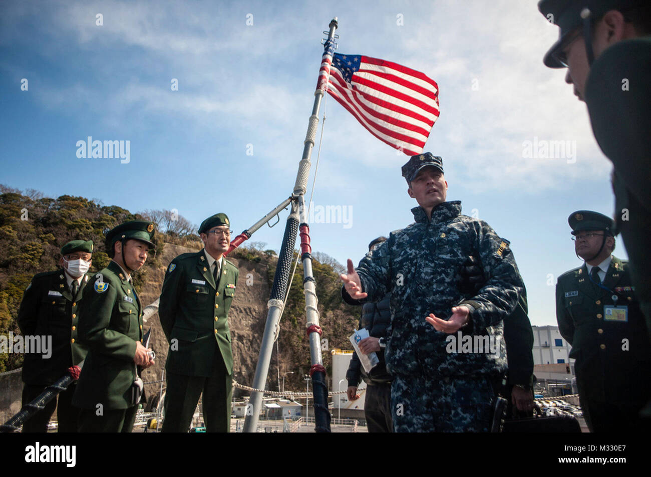 Gives a tour of the U.S. Navy's forward-deployed aircraft carrier USS ...