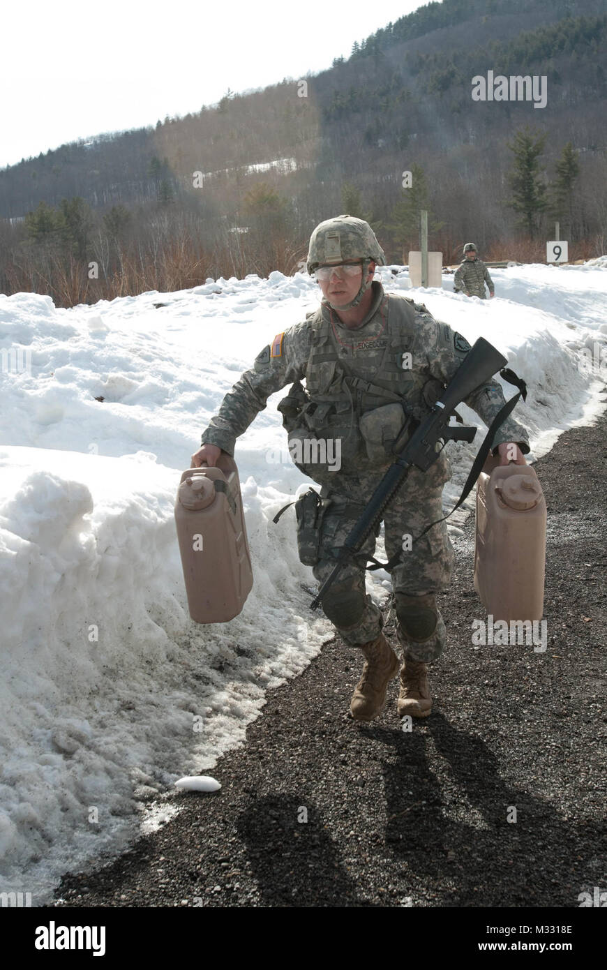 Sgt. Christopher Edgecomb, of the 133rd Engineer Battalion, carries two ...