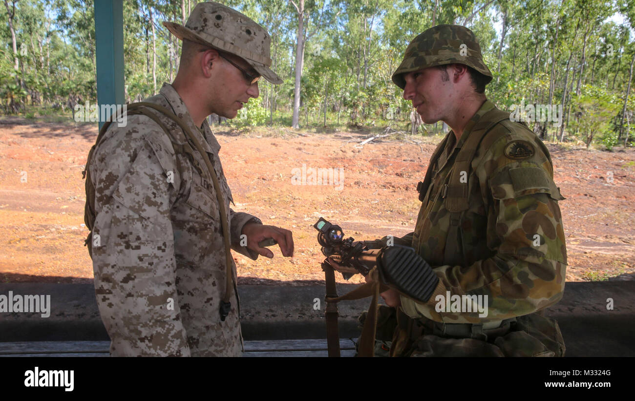 Shows a Soldier with the Australian Army how to fire their weapon ...