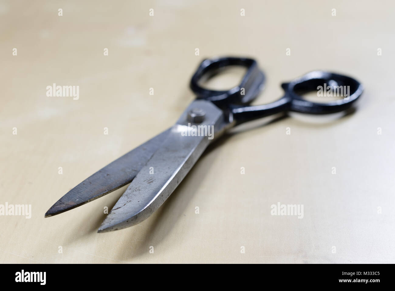 Garment accessories spread on a light wooden table. Threads, scissors ...