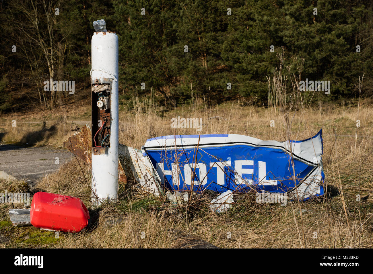 Old hotel signboard. A broken hotel and a sign showing its direction ...