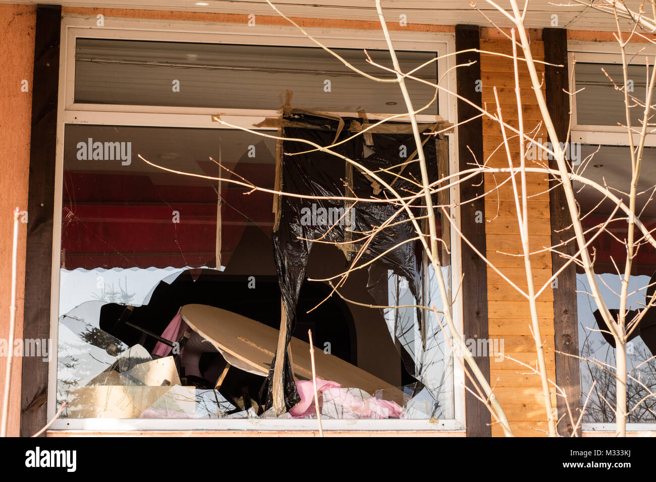 A broken window in an old abandoned building. Broken glass on the ...