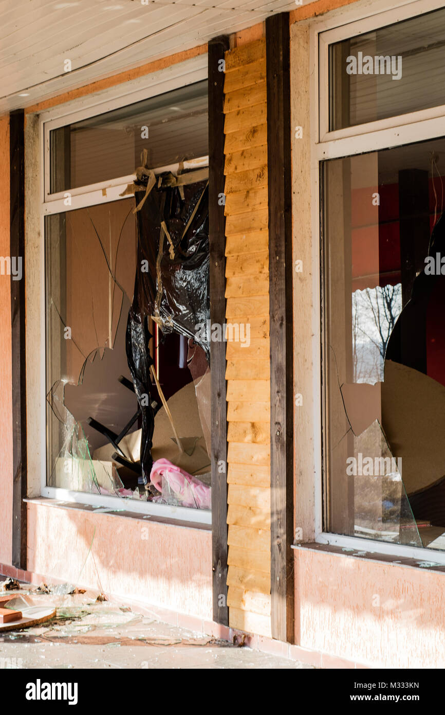 A broken window in an old abandoned building. Broken glass on the ...