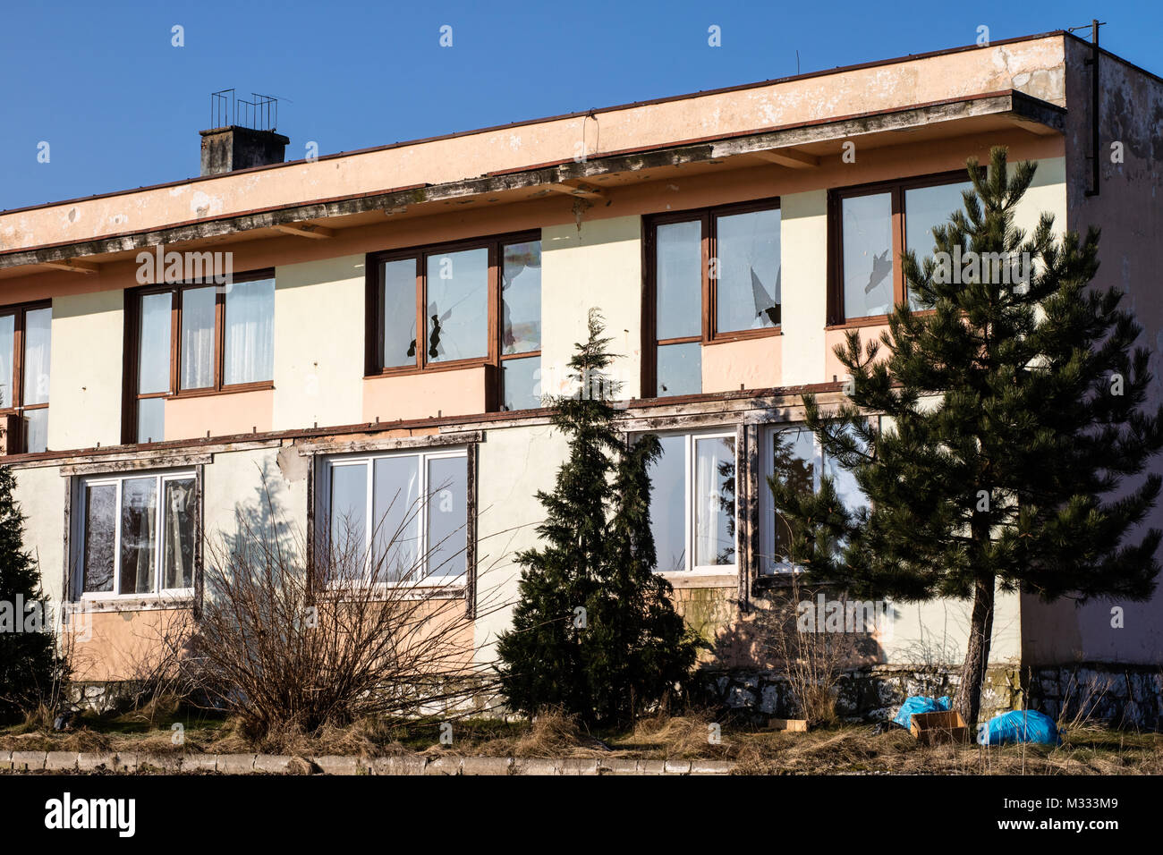 A broken window in an old abandoned building. Broken glass on the ...