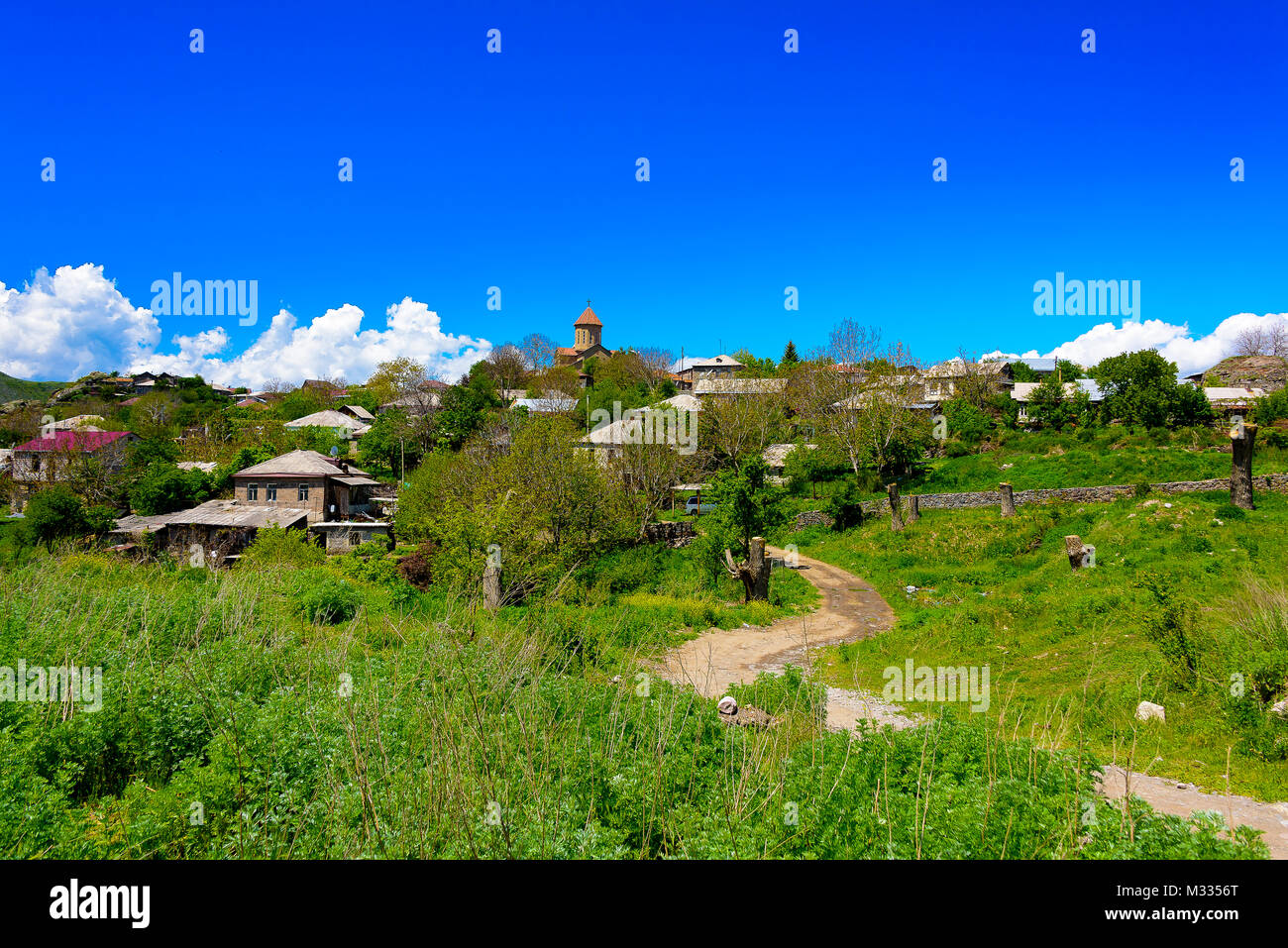 Georgian village , serene lush green forest landscape with blue skies ...