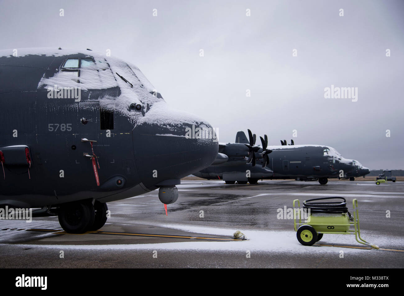 Snow covers HC-130J Combat King II aircraft on the flight line of Moody ...