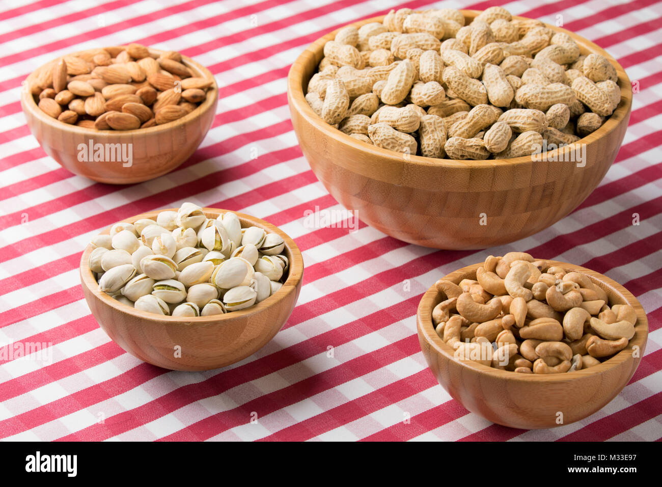 Close up of party bowls of peanuts, almonds, pistachios, and cashews on ...
