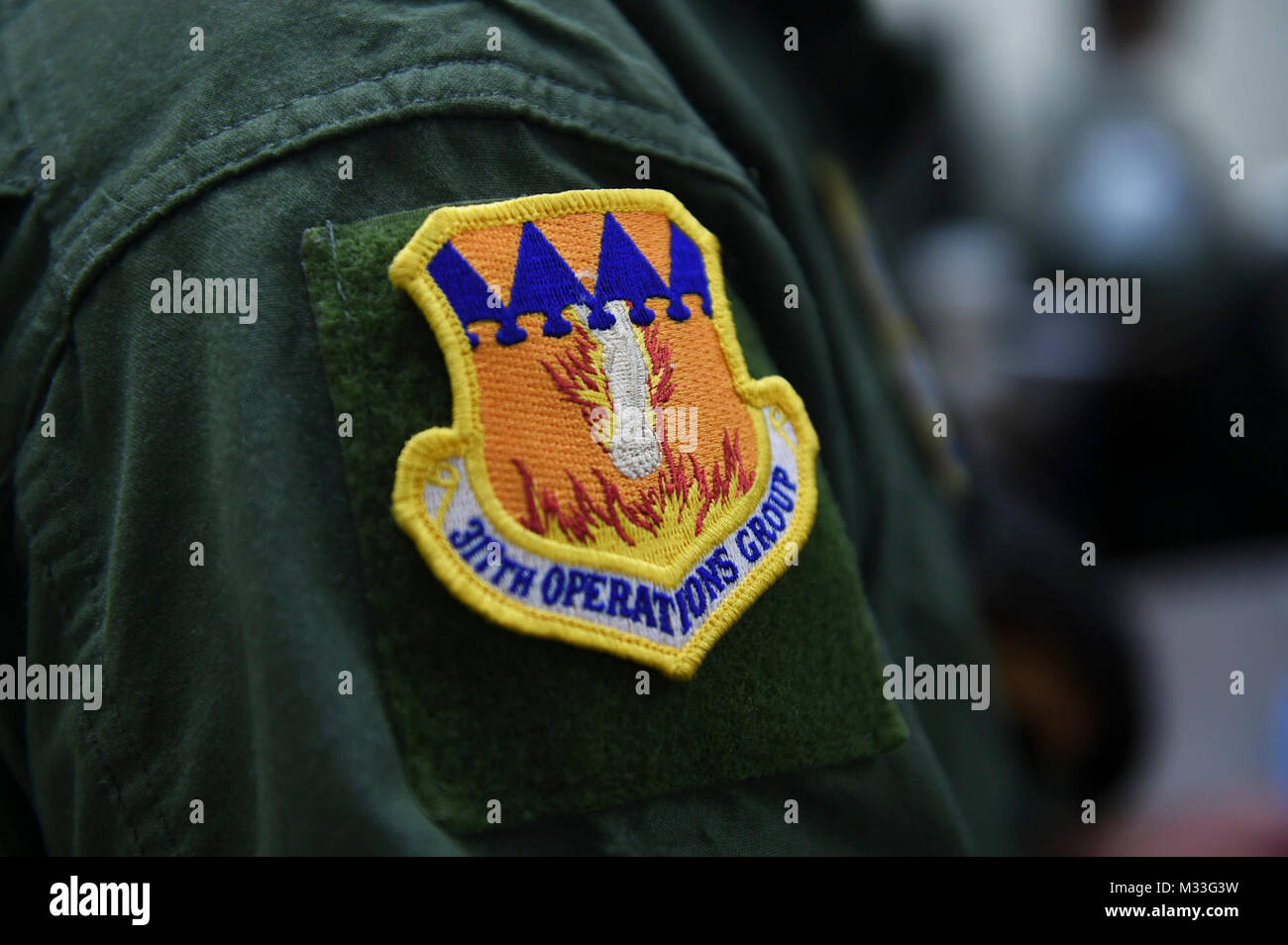 A U.S. Air Force Airman assigned to the 317th Operations Group wears a squadron patch on his ...