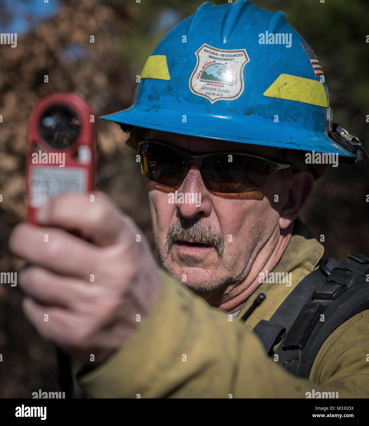 Keith Hawk, prescribed fire specialist, checks wind conditions before a ...