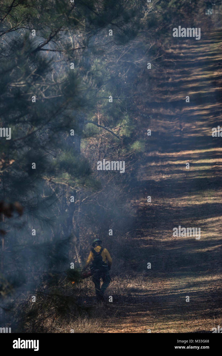 Andrew Addie, wildland firefighter, starts a test fire at Barksdale Air ...