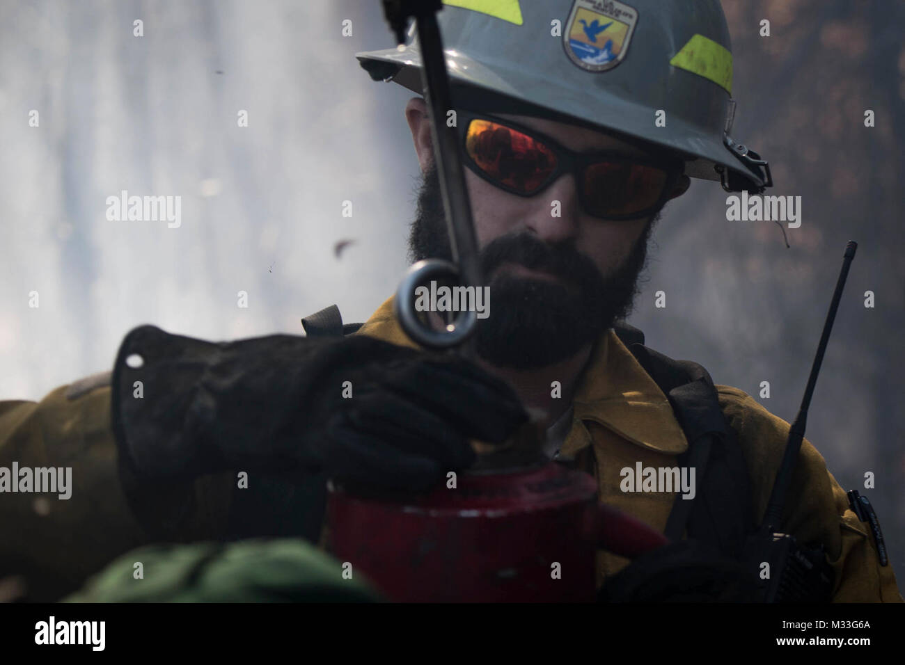 Robert Heartman, wildland firefighter, prepares a torch during a ...