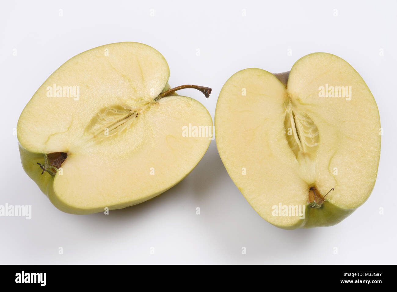 Two halves of a cut green apple on a white background Stock Photo - Alamy