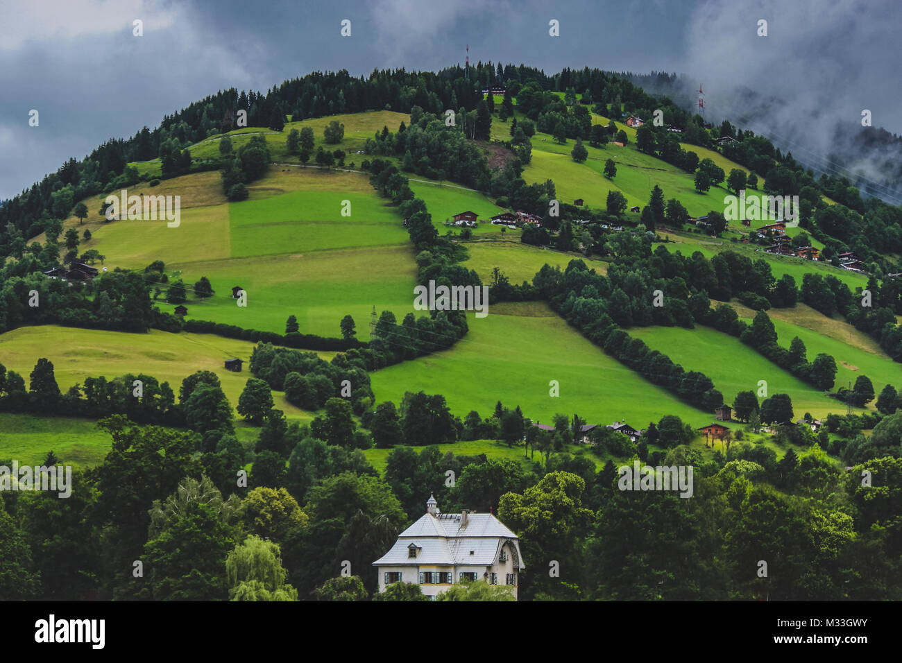 Alpine homes on the mountainside of Zell am See Lake, Austria, Europe on a rainy day Stock Photo ...