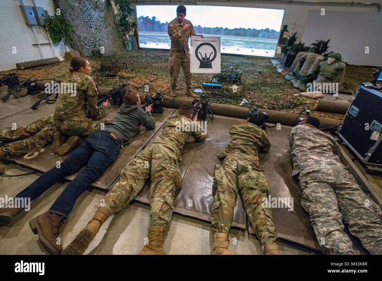 U.S. Army Capt. Eric Venditti, center, explains the proper alignment of ...