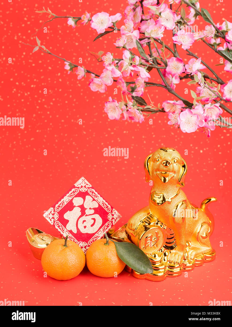 golden dog statue on red paper,translation of calligraphy: good Fortune ...