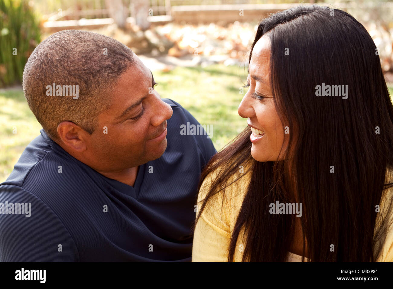 Smiling man and woman in loving stare with each other Stock Photo - Alamy