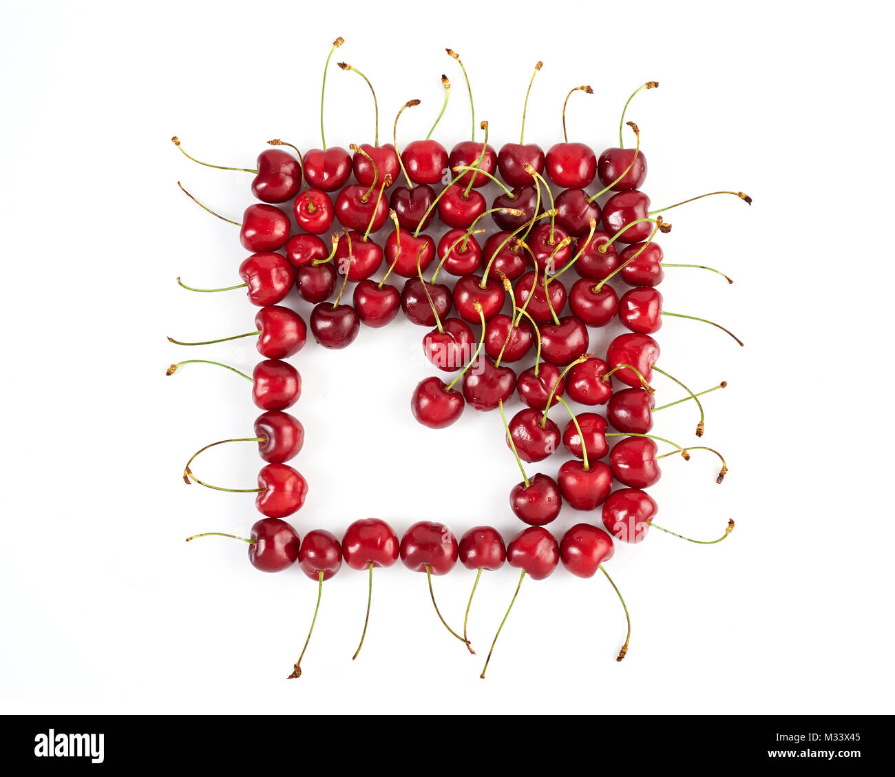 Ripe cherries placed in square with heart sign. Top view Stock Photo ...