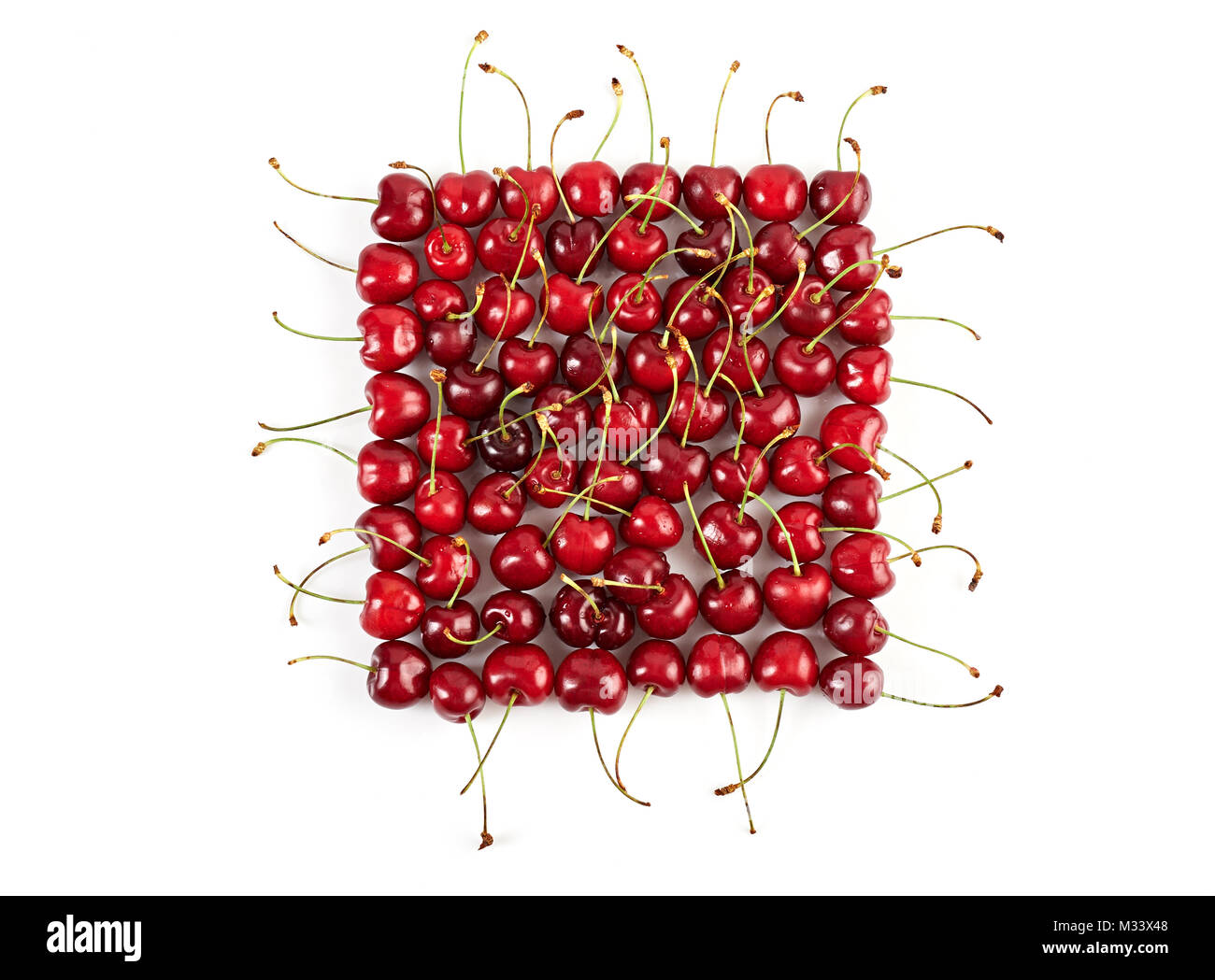 Ripe cherries placed in square shape isolated on white background. Top ...