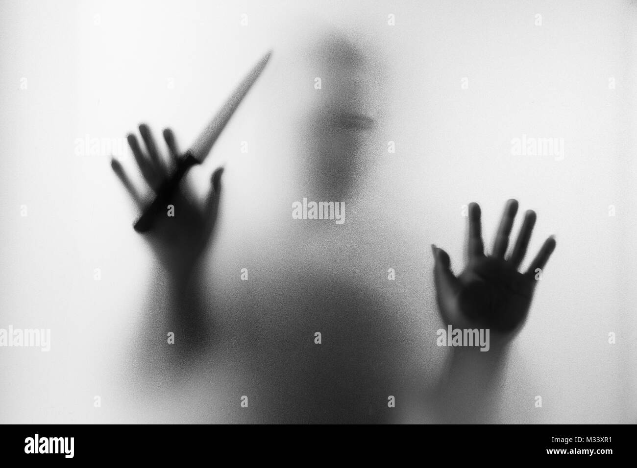 Horror Murderer. Dangerous man behind the frosted glass with a knife on ...