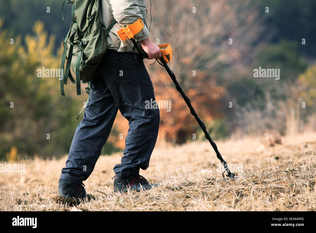 man hunt treasure with metal detector in autumn forest Stock Photo - Alamy