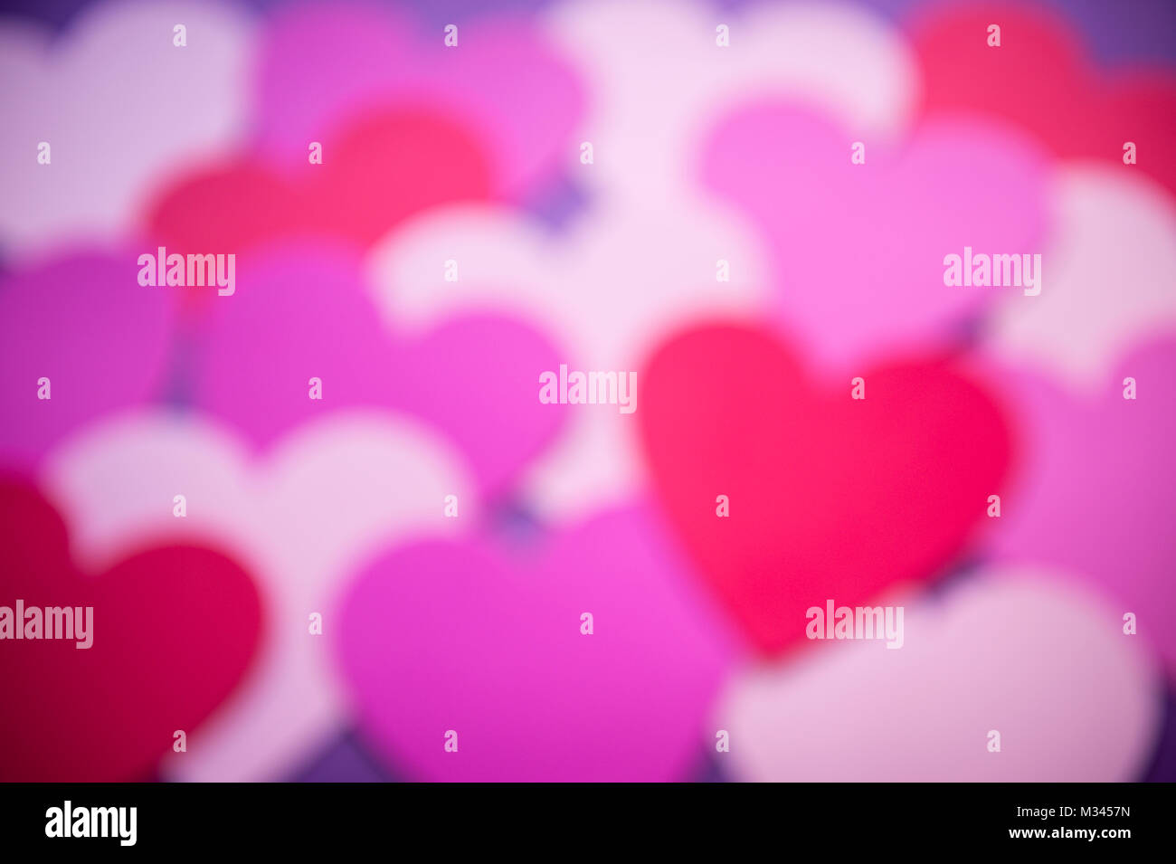Valentine's Day background of layered hearts in shades of red, purple ...