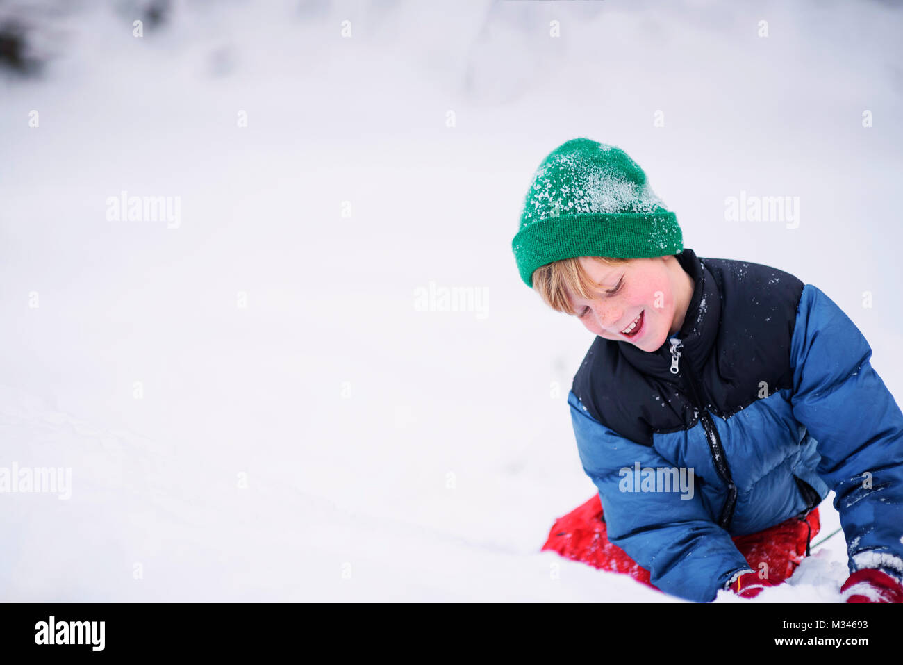 Smiling Boy playing in the snow Stock Photo - Alamy
