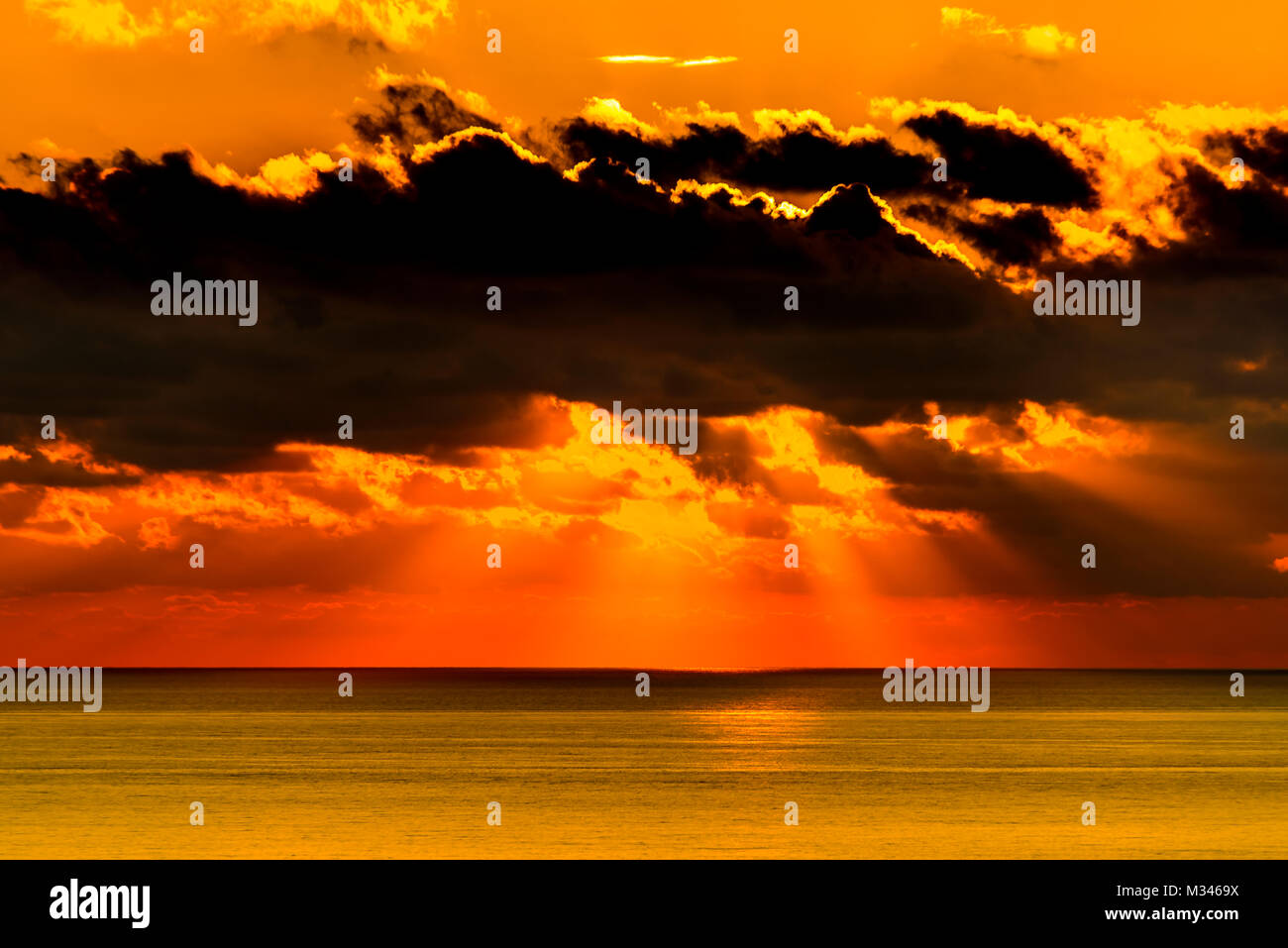Stylized long exposure sunset seascape with different shades of red ...