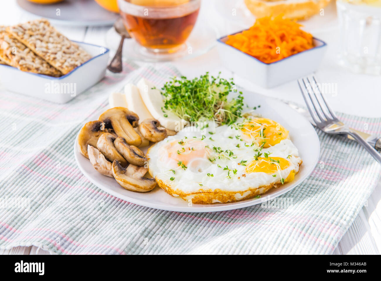 Healthy breakfast plate with scrambled eggs, cheese, grilled mushrooms ...