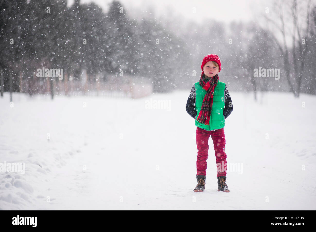 Boy standing in the snow Stock Photo - Alamy