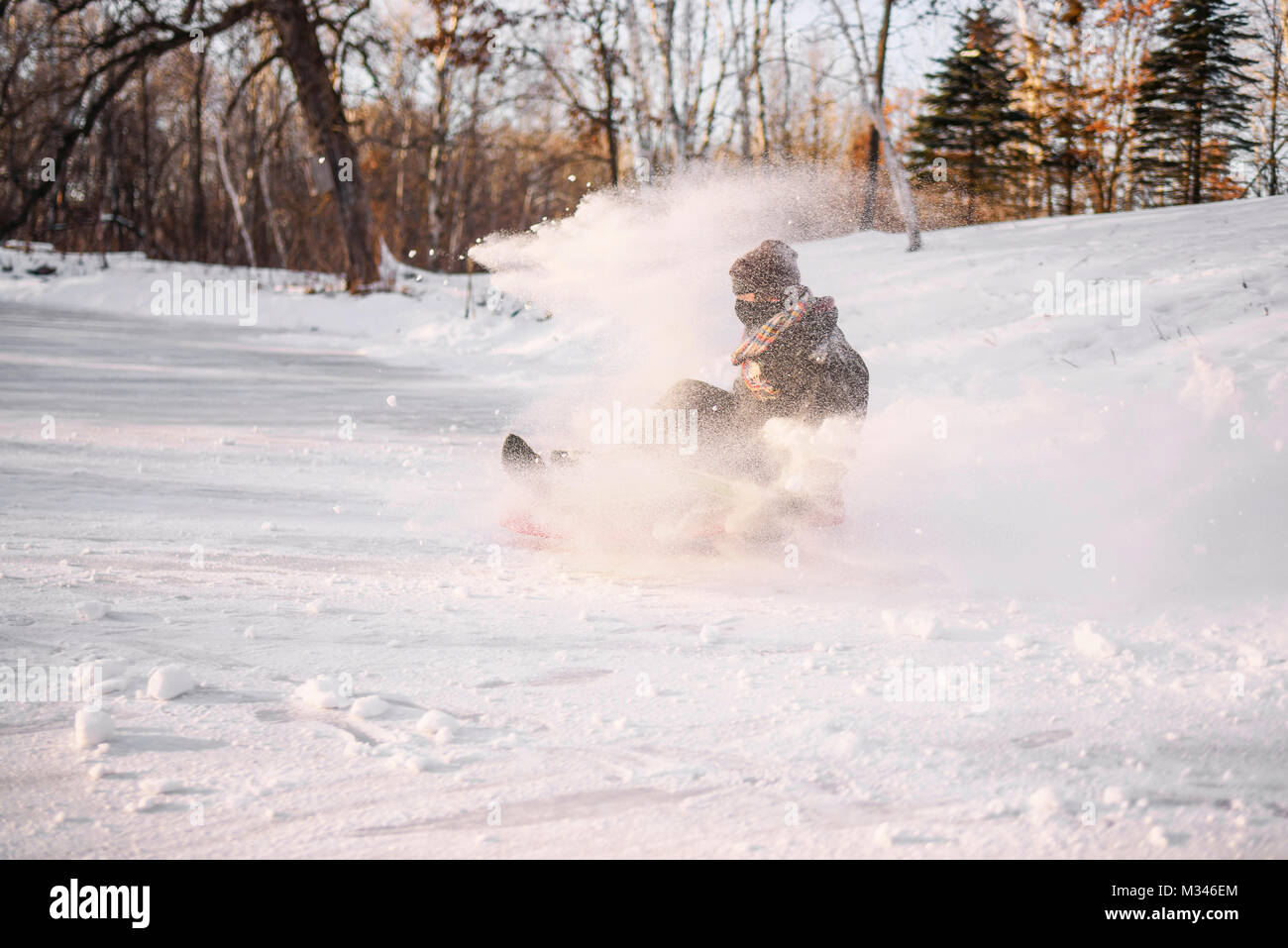 Man sledging in snow Stock Photo - Alamy