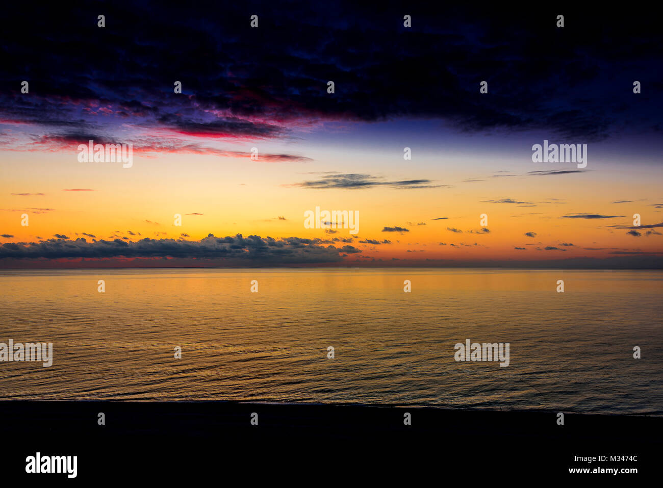 Stylized long exposure sunset seascape with different shades of red ...