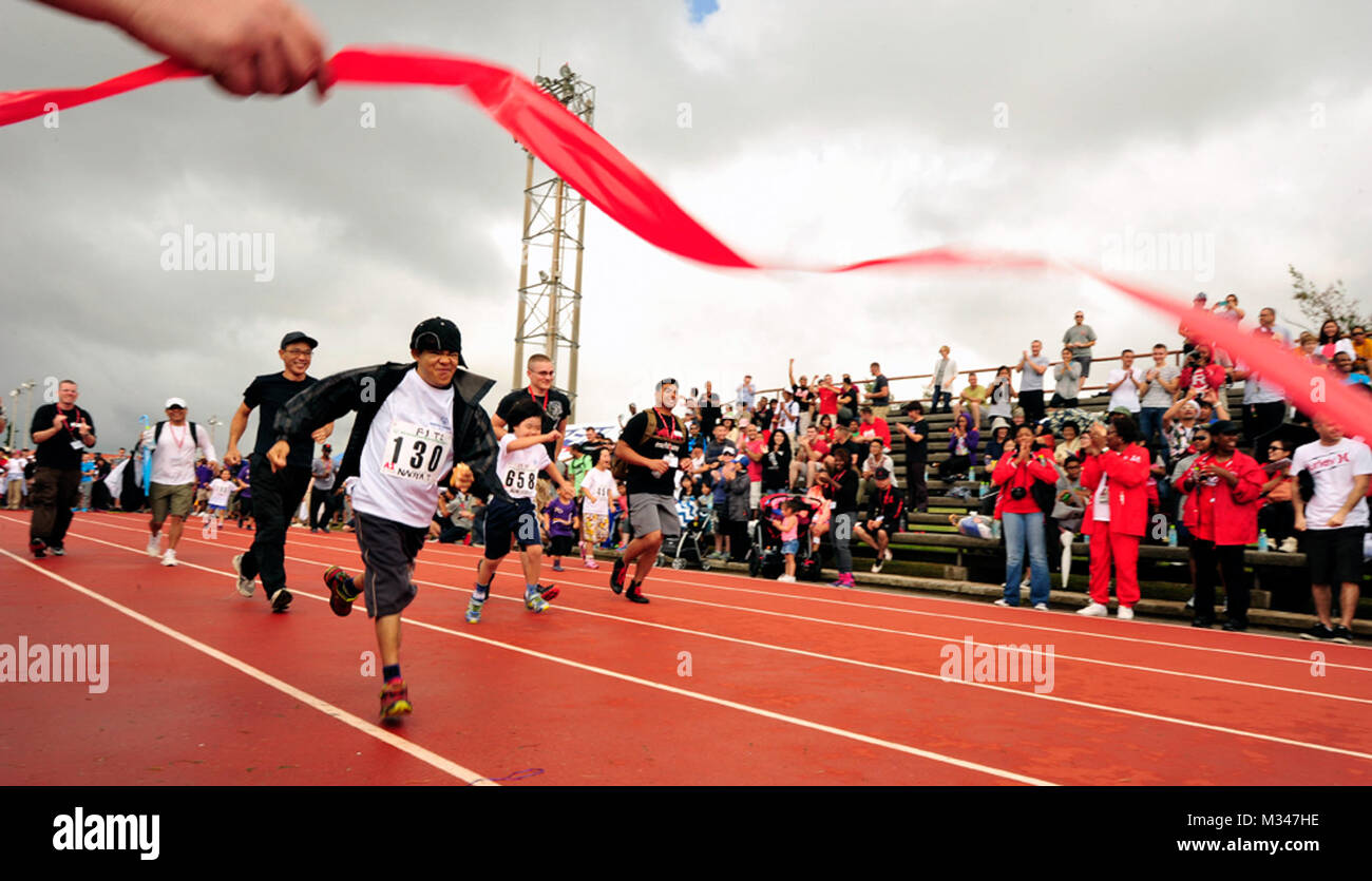 Japanese athletes and their helpers run the 30-meter dash during the ...