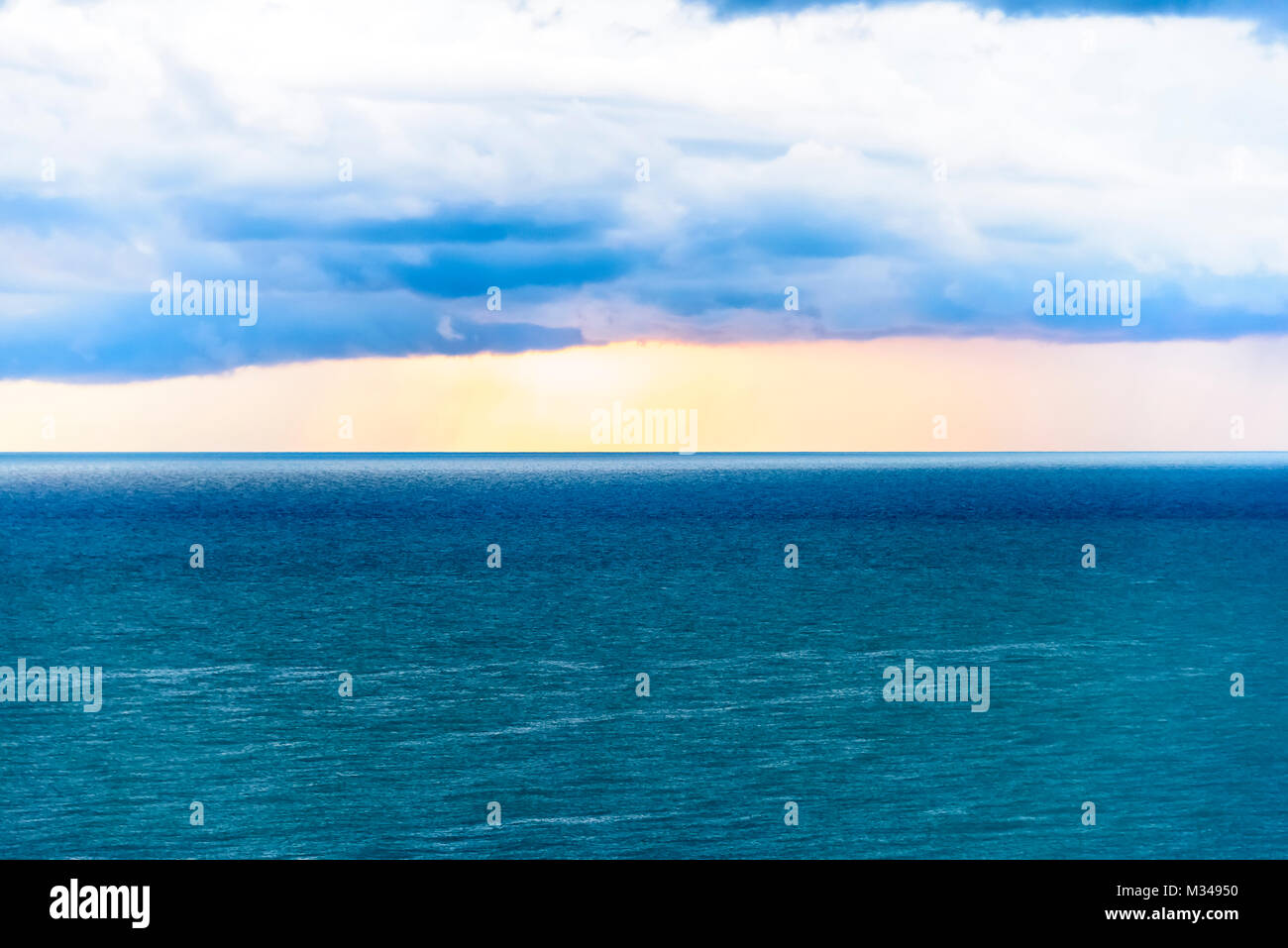A calming, relaxing seascape oceanscape sunset showing a blue sea, blue ...