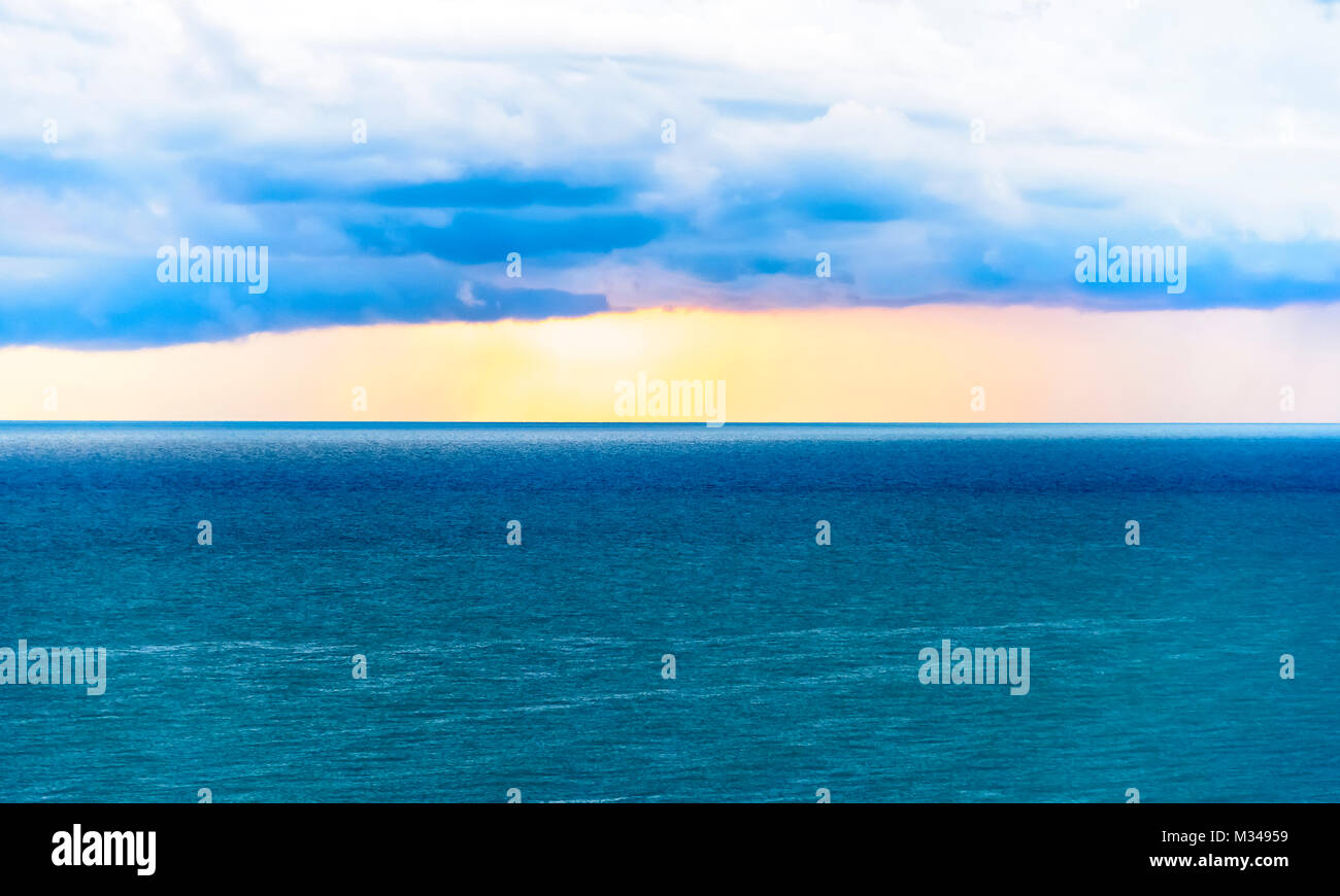 A calming, relaxing seascape oceanscape sunset showing a blue sea, blue ...