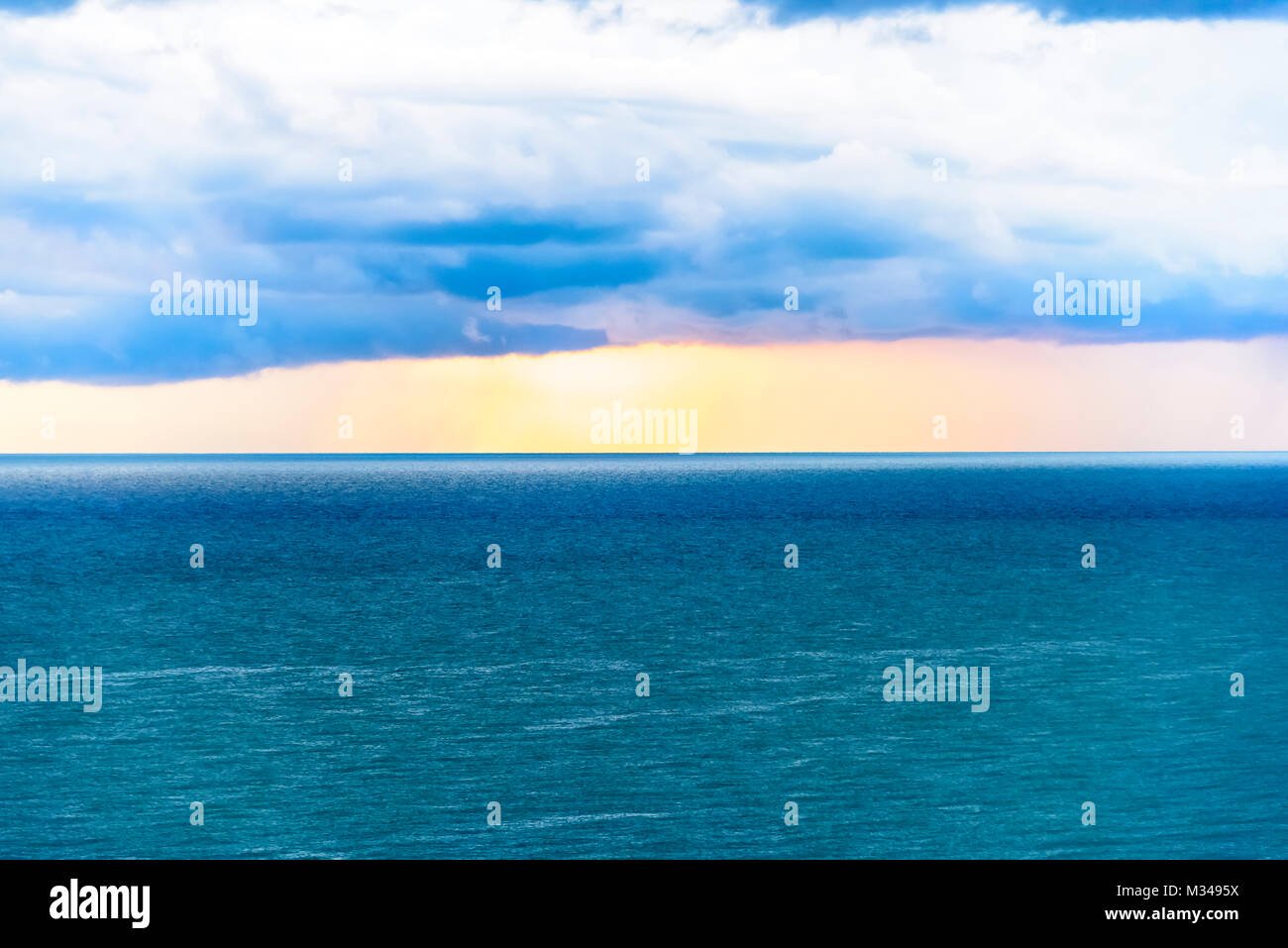 A calming, relaxing seascape oceanscape sunset showing a blue sea, blue ...