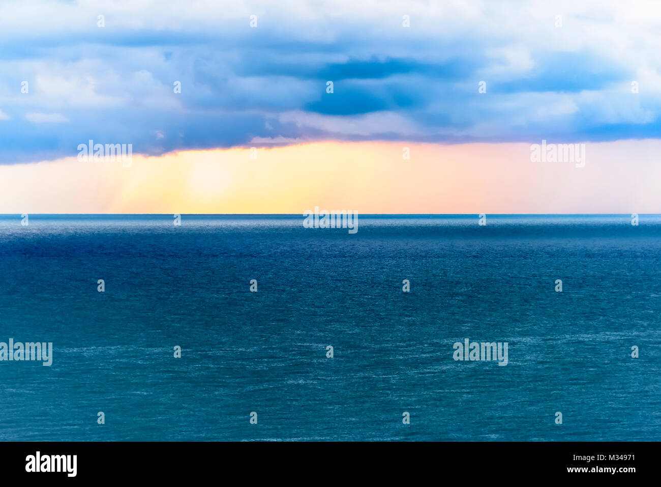 A calming, relaxing seascape oceanscape sunset showing a blue sea, blue ...