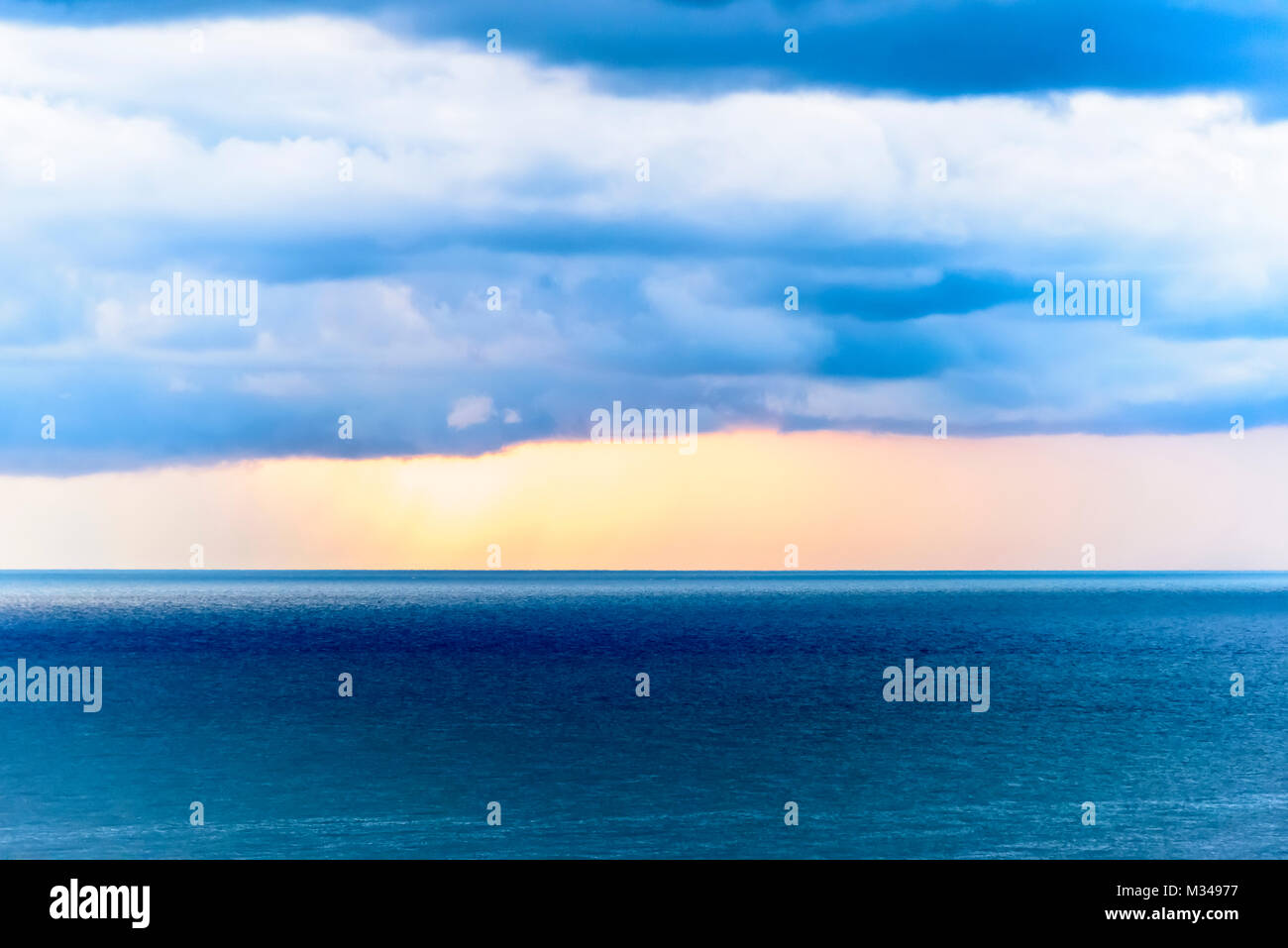 A calming, relaxing seascape oceanscape sunset showing a blue sea, blue ...
