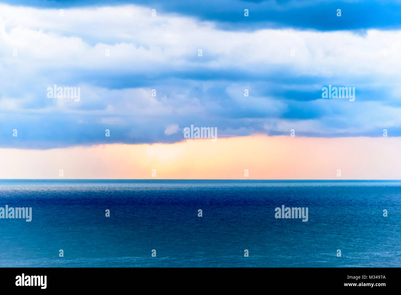A calming, relaxing seascape oceanscape sunset showing a blue sea, blue ...