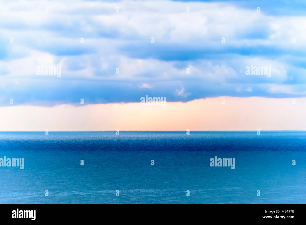 A calming, relaxing seascape oceanscape sunset showing a blue sea, blue ...