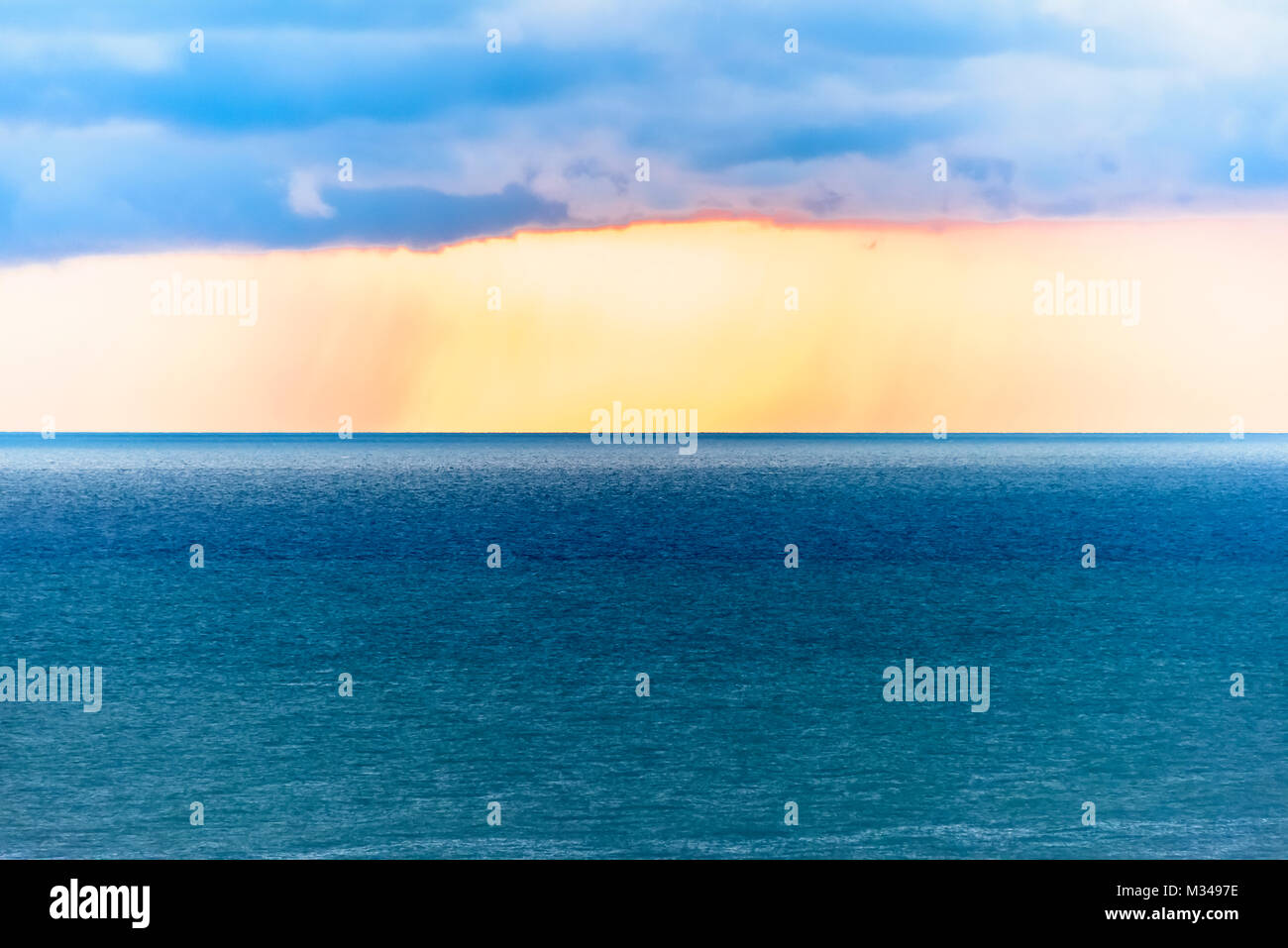 A calming, relaxing seascape oceanscape sunset showing a blue sea, blue ...